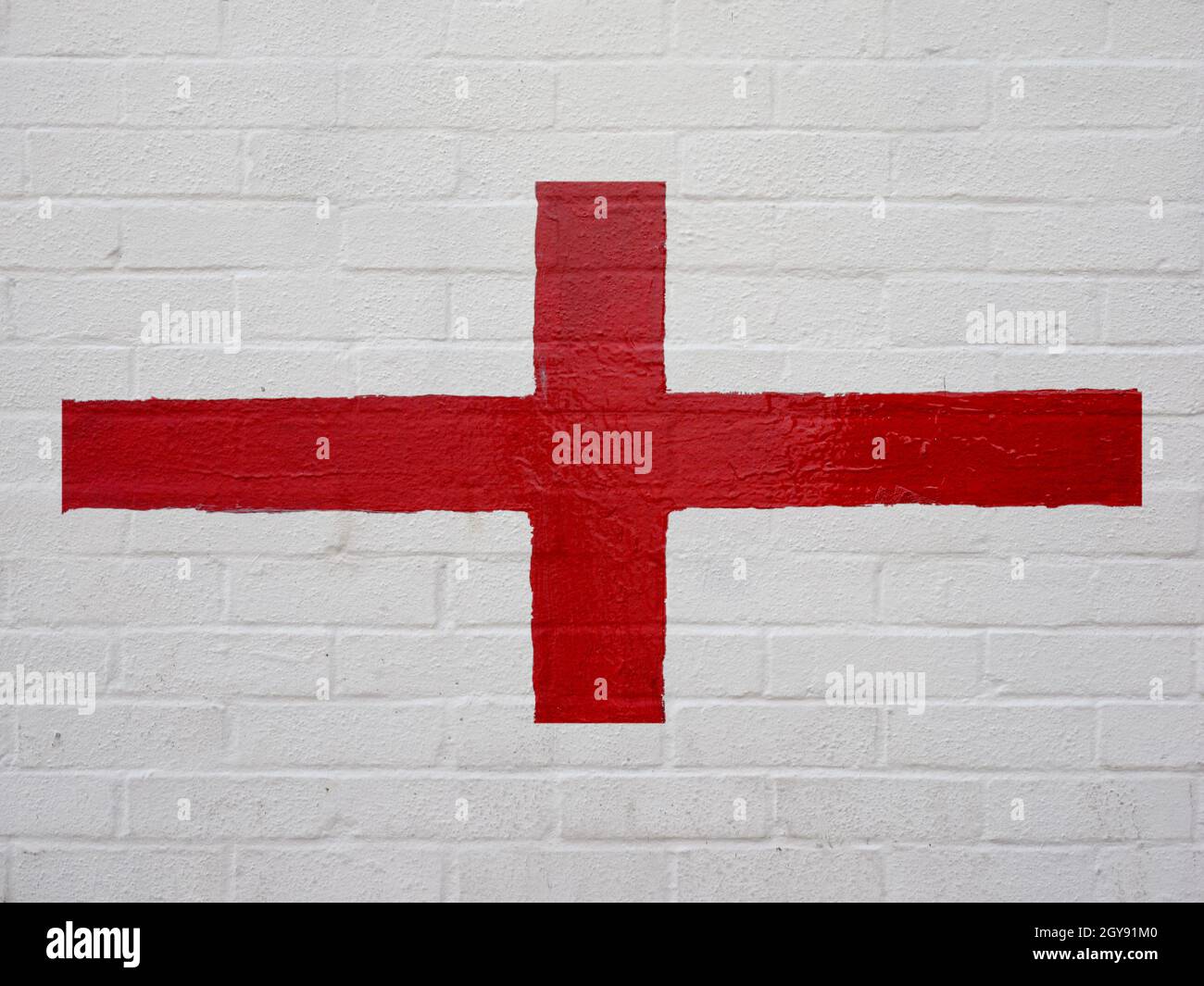 the English national flag of England, UK painted on a white brick wall ...