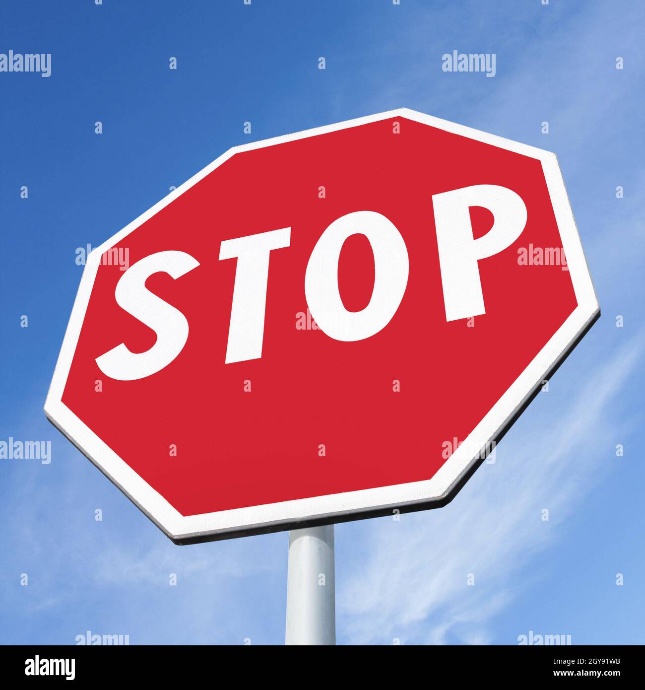 Stop sign on sky. Stop sign against a blue sky Stock Photo - Alamy