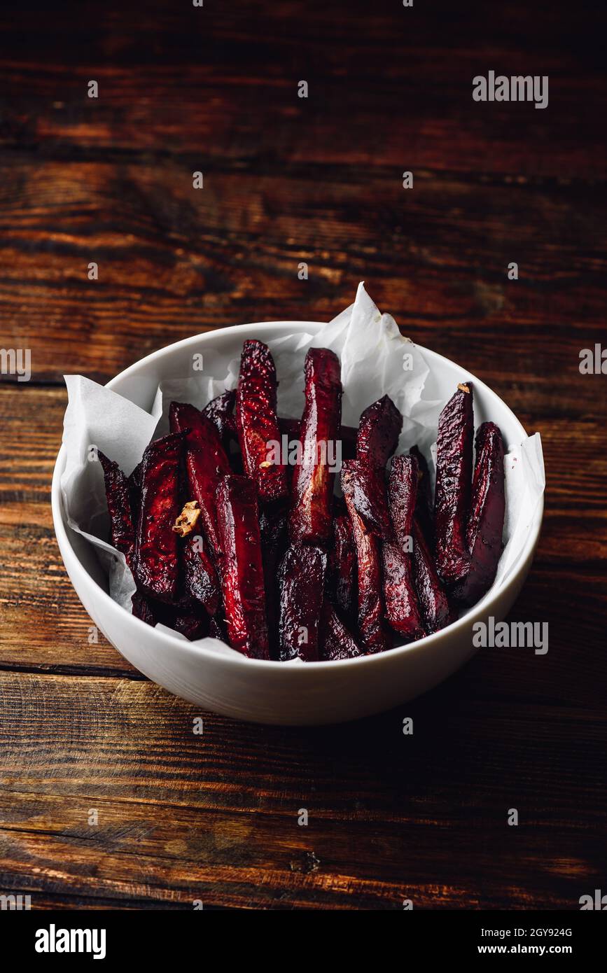 Oven baked beet fries in white bowl Stock Photo - Alamy