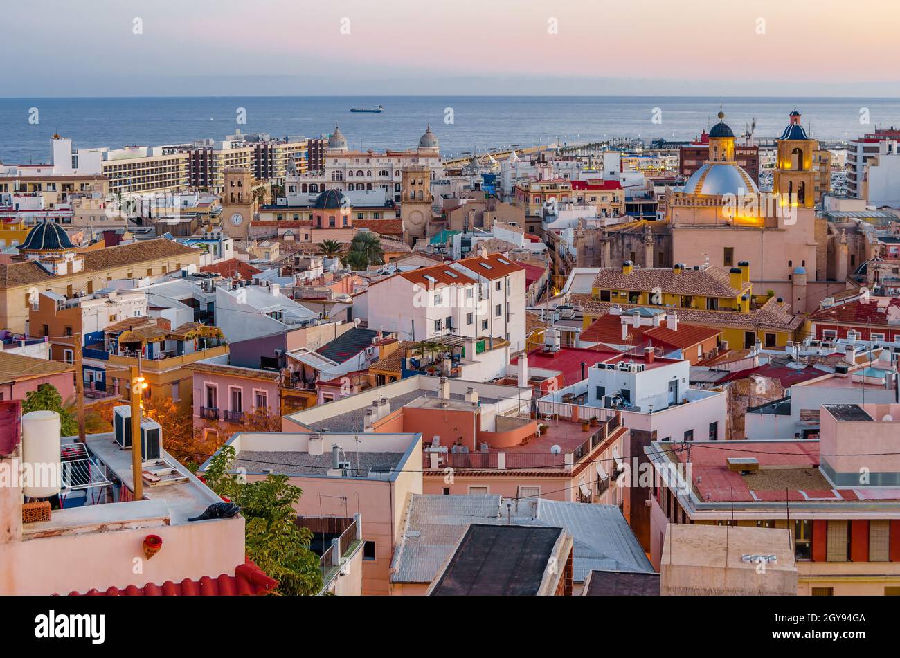 Alicante cityscape at dusk, showing the cathedral with the sea in the ...