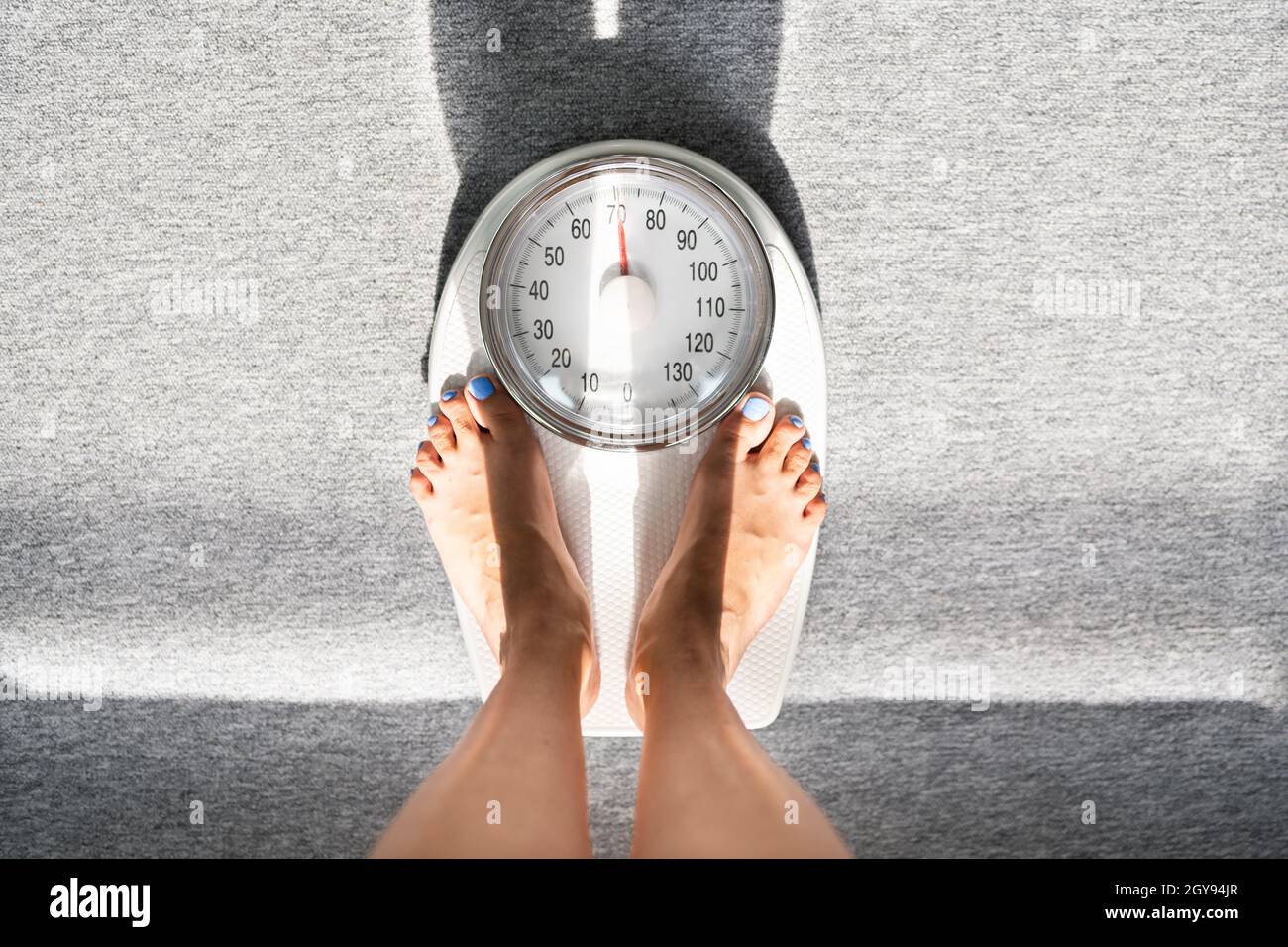 Weighing Scale Weight Check And Measure. Lady Standing After Workout ...