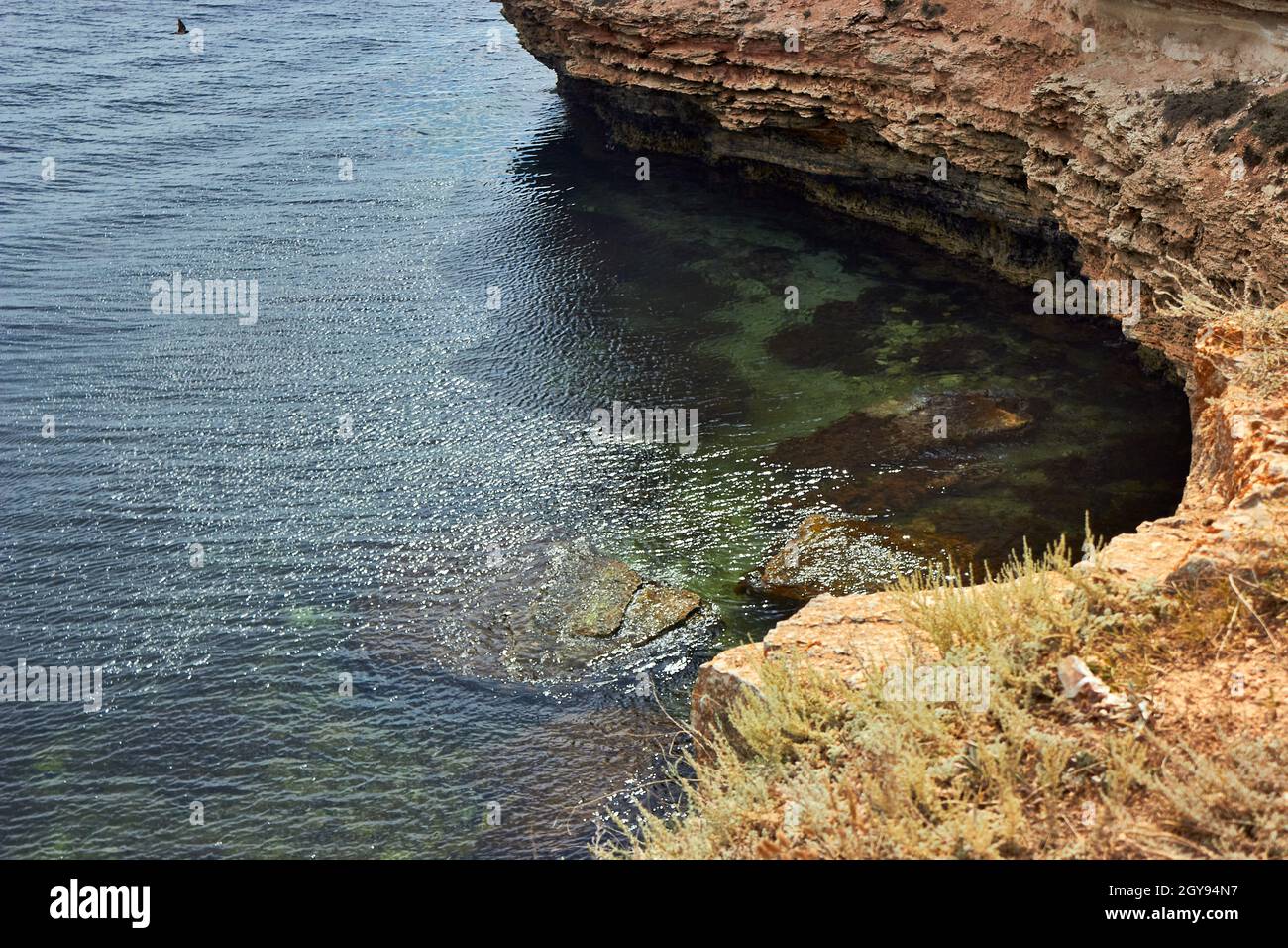 Yellow rocky seashore, cliff. Blue deep calm sea. Top view of the ...