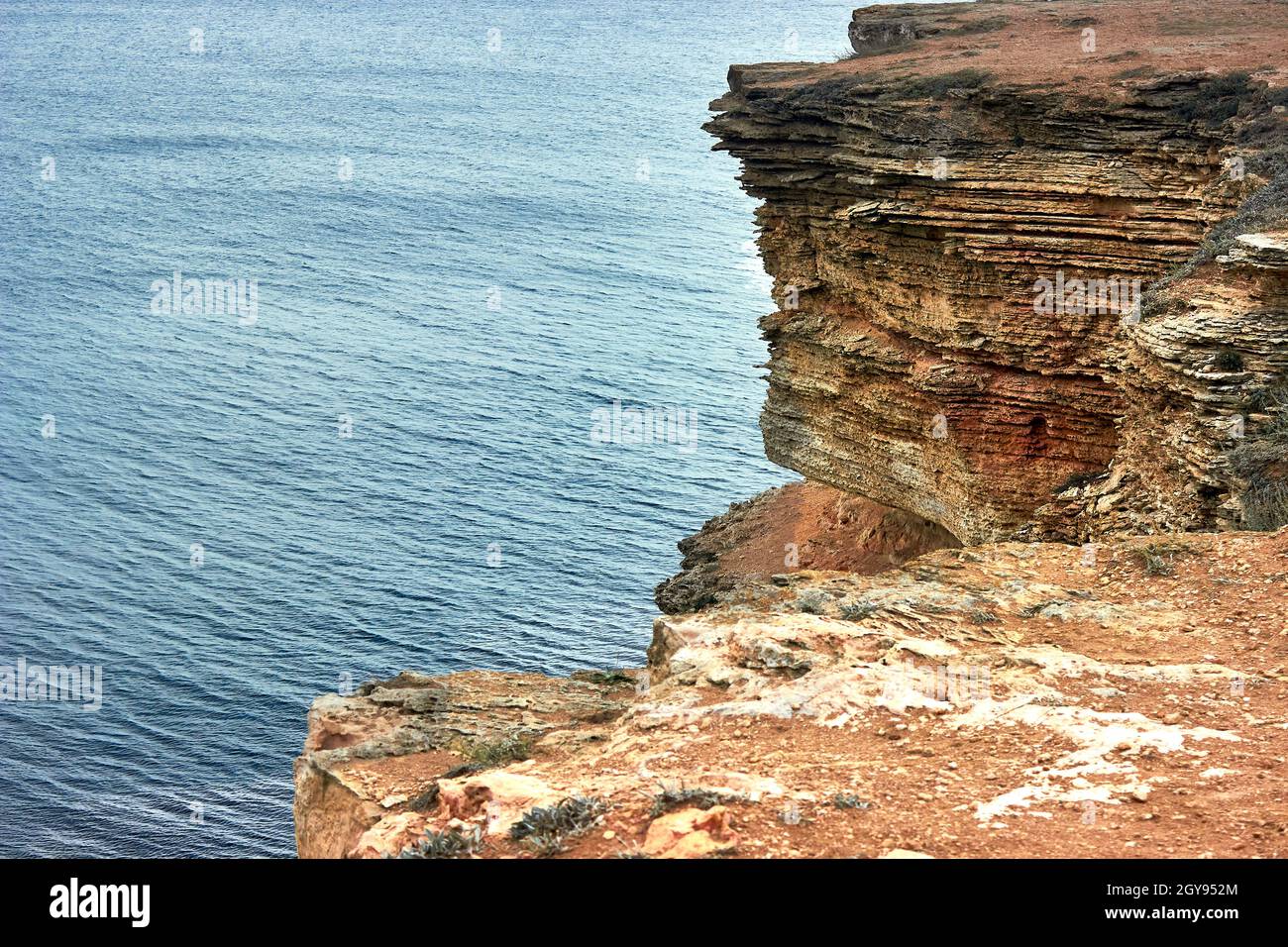 Yellow rocky seashore, cliff. Blue deep calm sea. Top view of the ...
