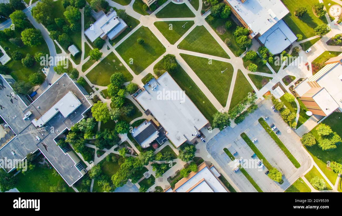 Bird's eye view of a college campus with roads cutting through green ...