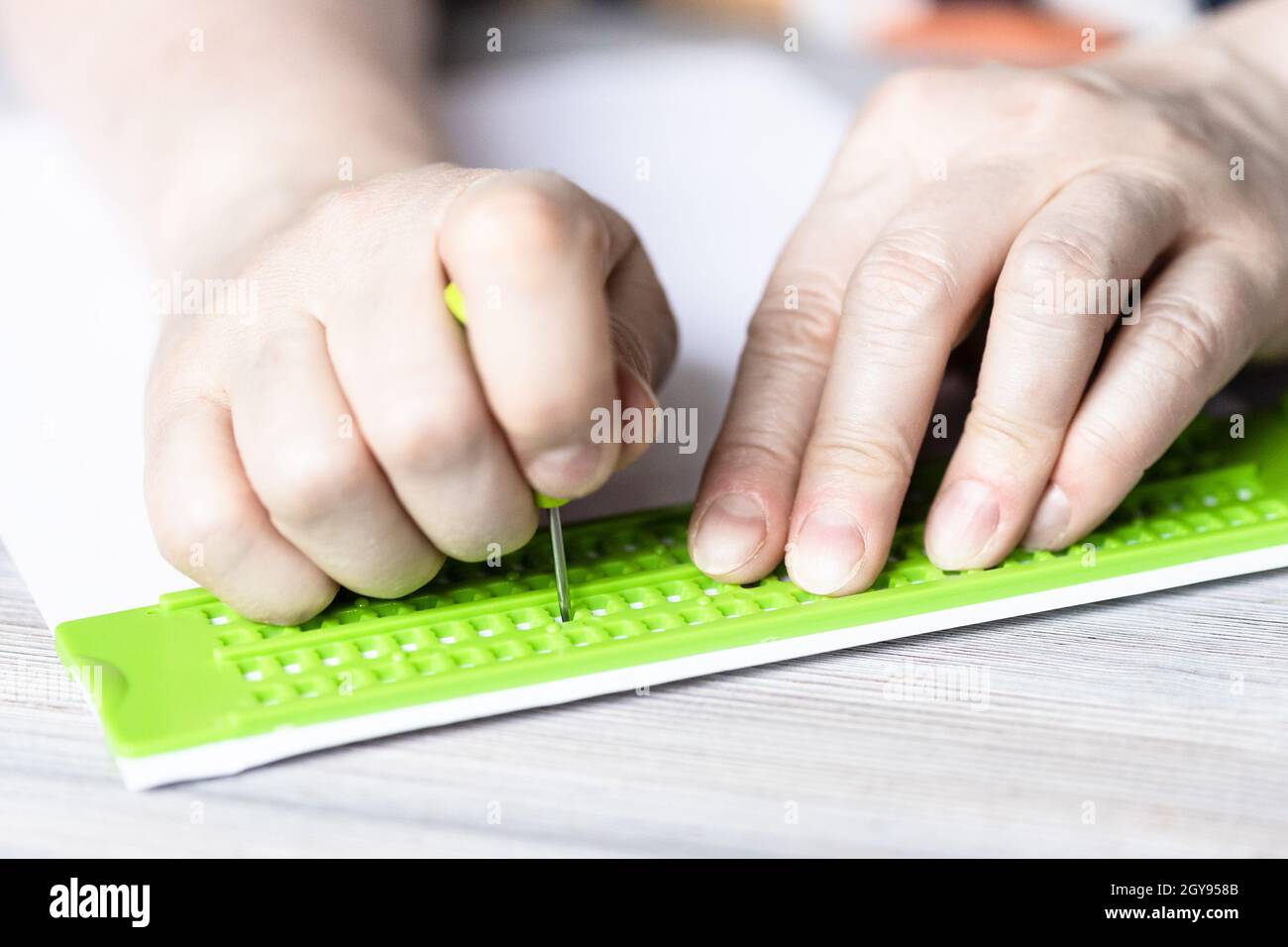 front view of typing in braille with slate and stylus close up Stock ...