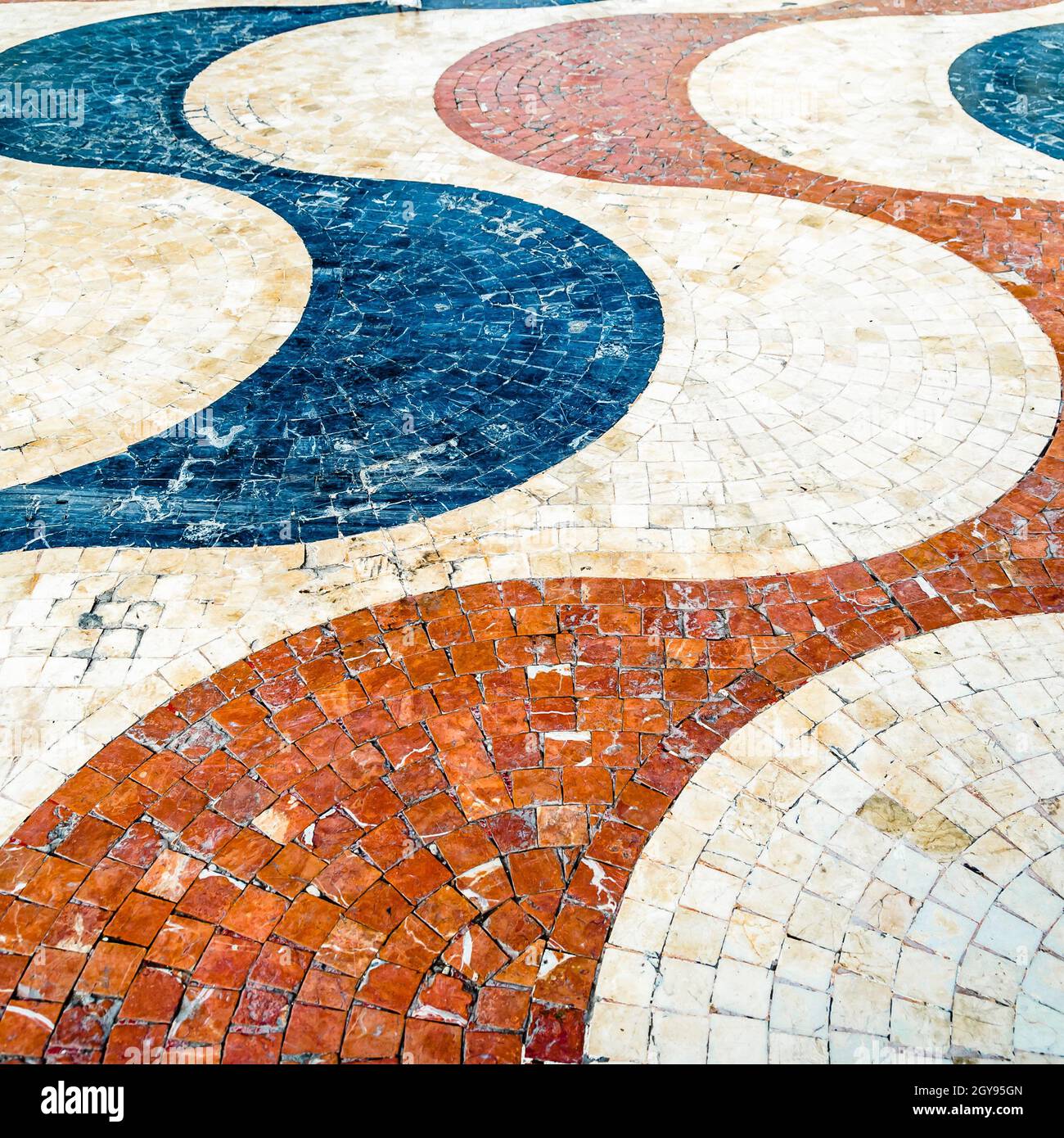 Colorful cobblestone pavement in Alicante, Spain, textured background ...