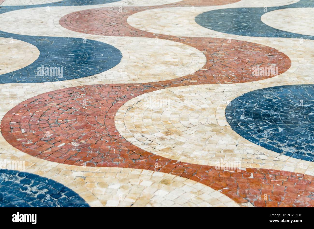 Colorful cobblestone pavement in Alicante, Spain, textured background ...
