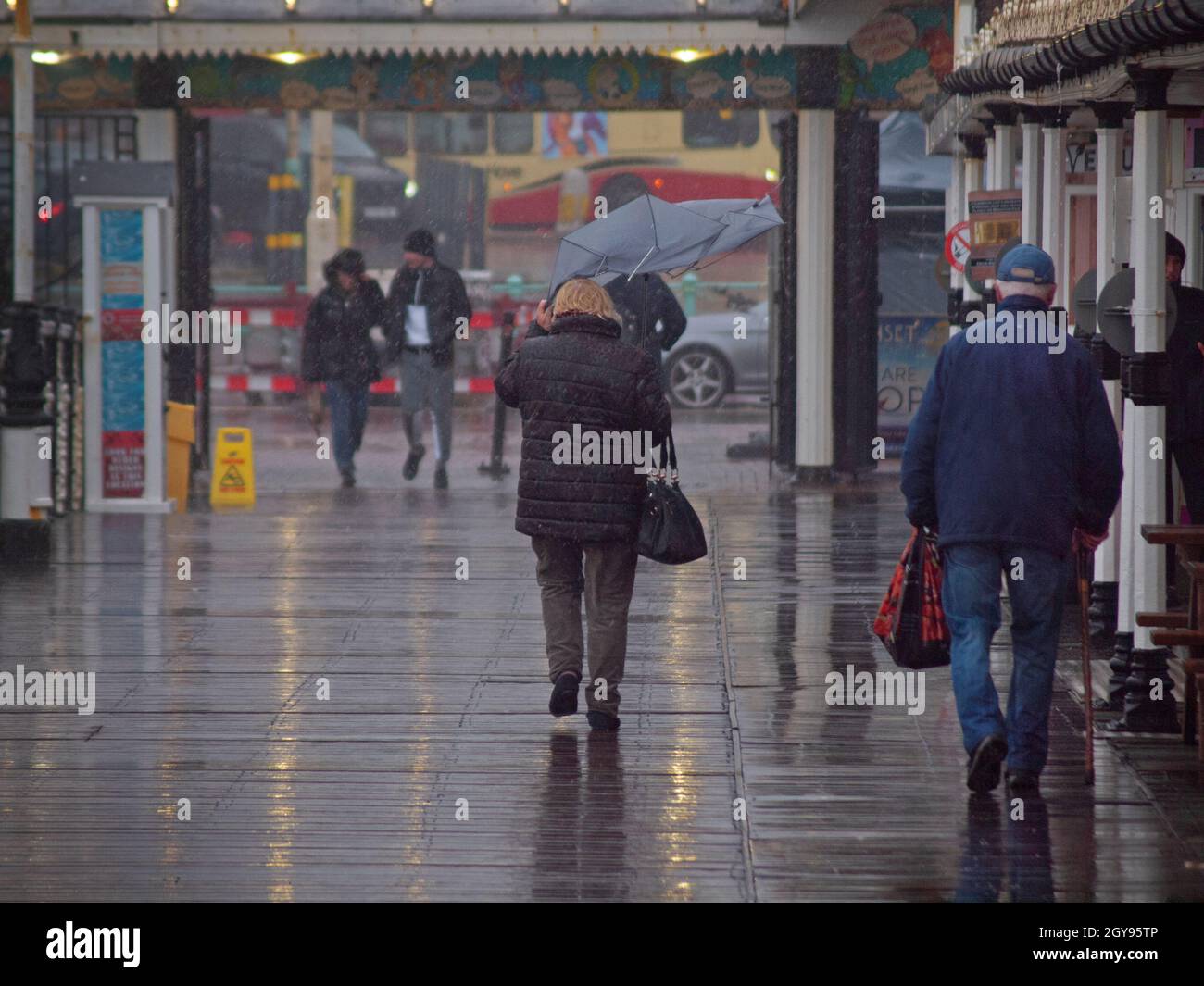 A wet day on the pier at Brighton Stock Photo - Alamy