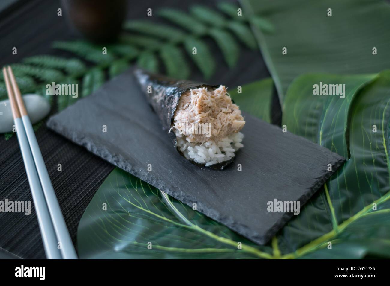 Temaki Tuna Sushi on restaurant table served on black tray with ...