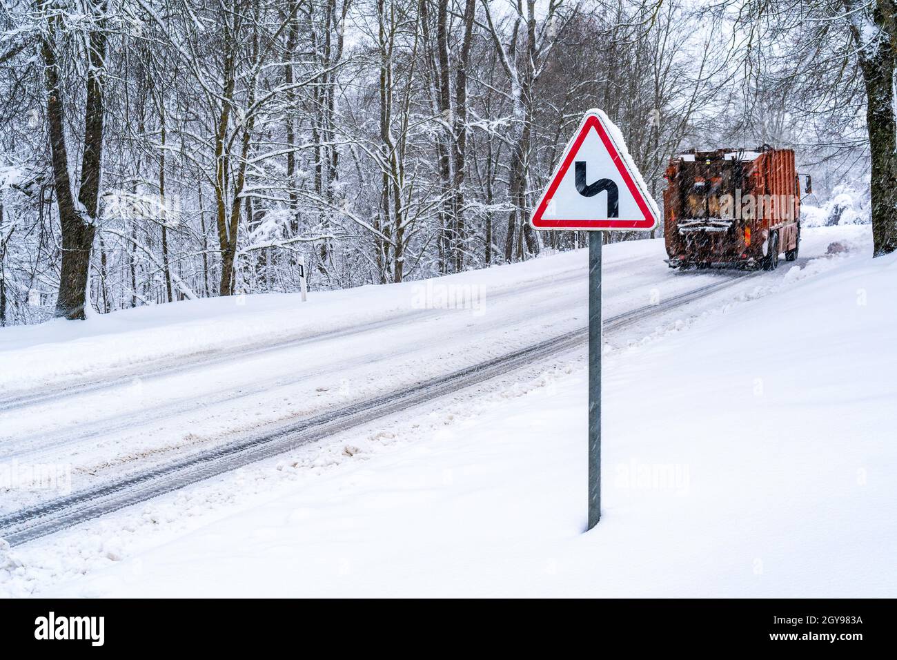 Heavy transport on the curvy snowy country road Stock Photo - Alamy