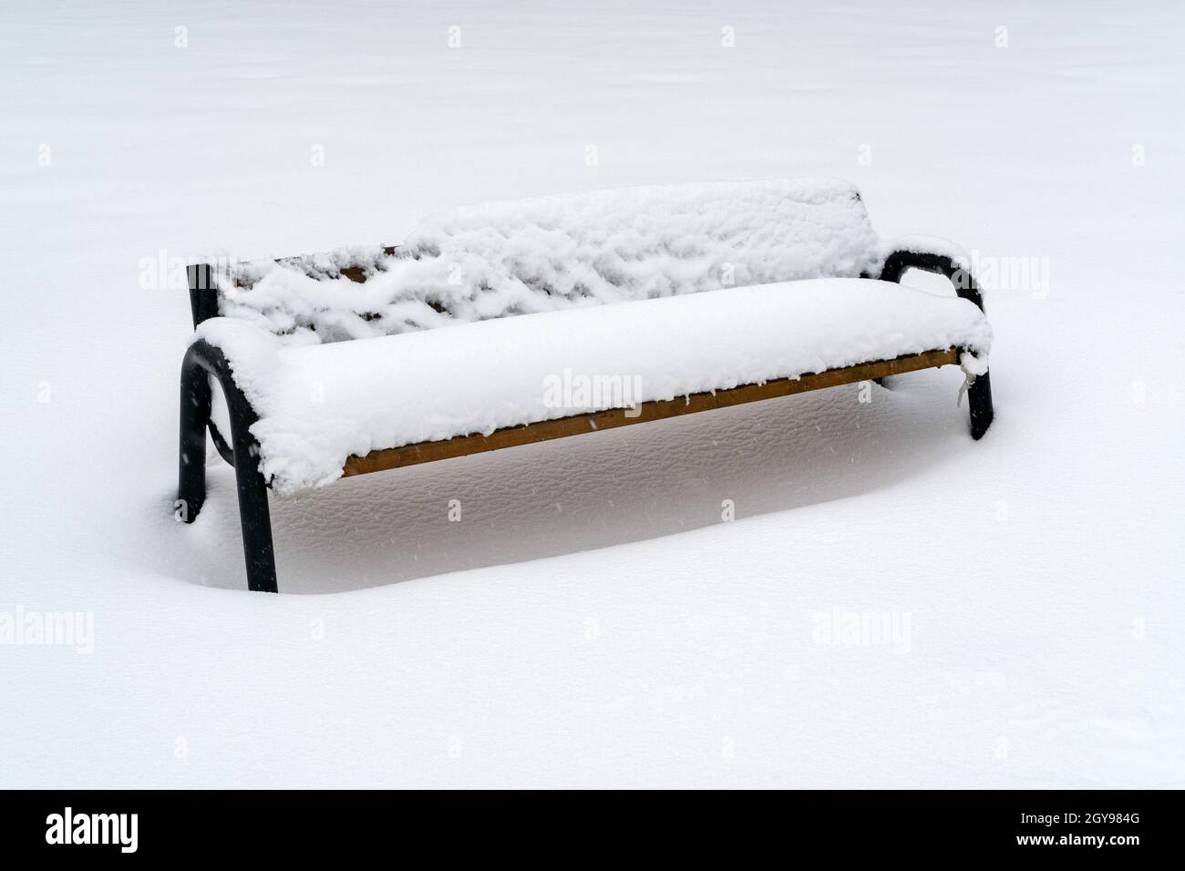 Wooden bench in deep snow after heavy snowfall Stock Photo - Alamy