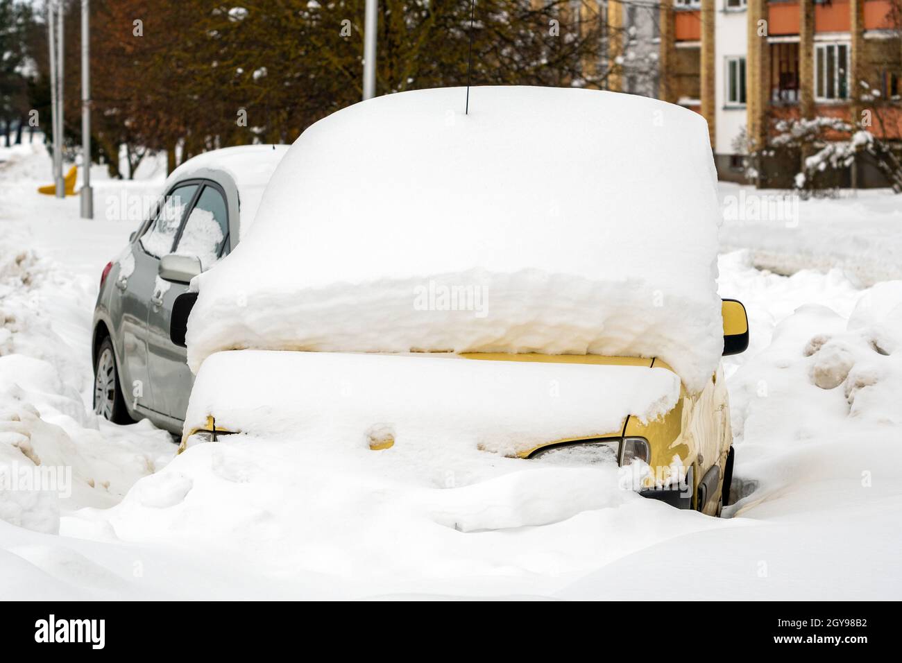 Car under the snow. A lot of snow after a snowfall. The car is ...