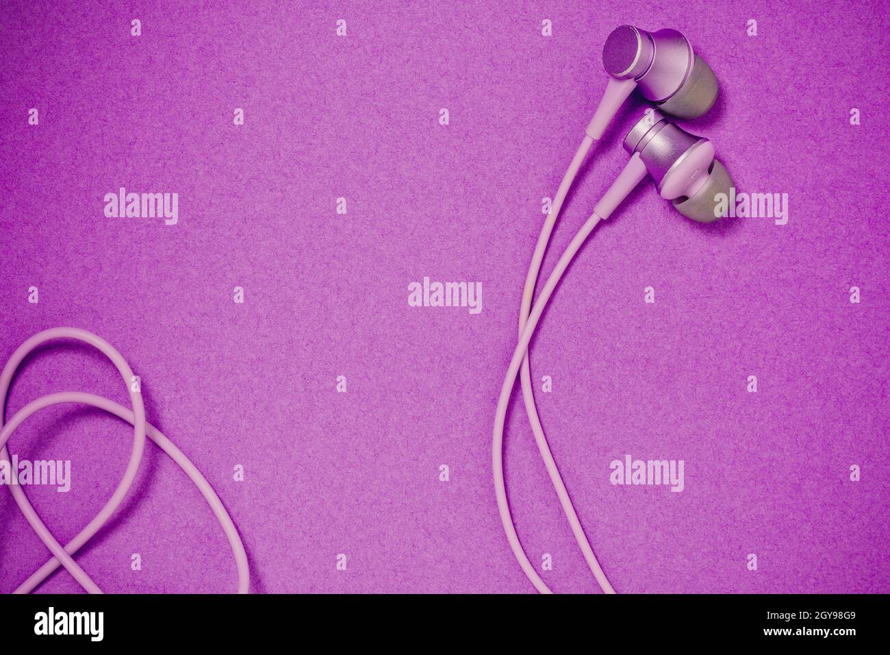 Flat lay concept: headphones on pastel backgrounds. Purple headphones ...