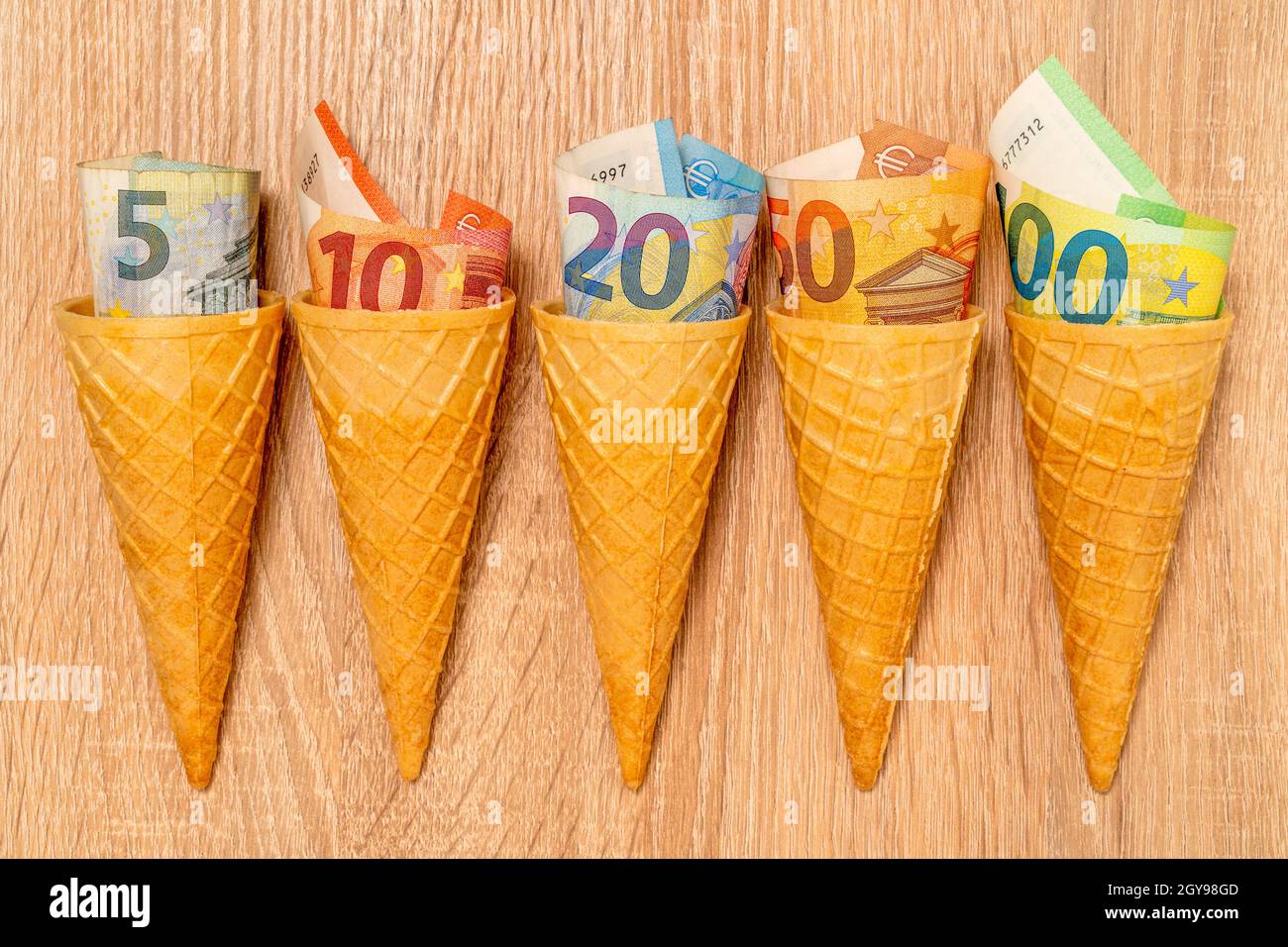 Euro bills rolled in ice cream cones. Waffle cones and money Stock ...