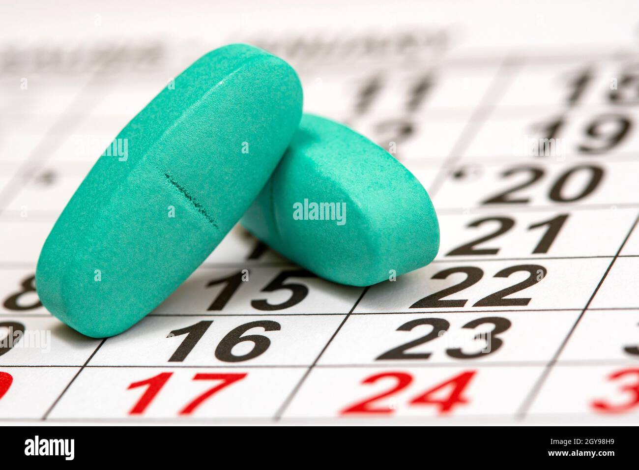 Medical pills on a calendar sheet with dates and numbers. Improper ...