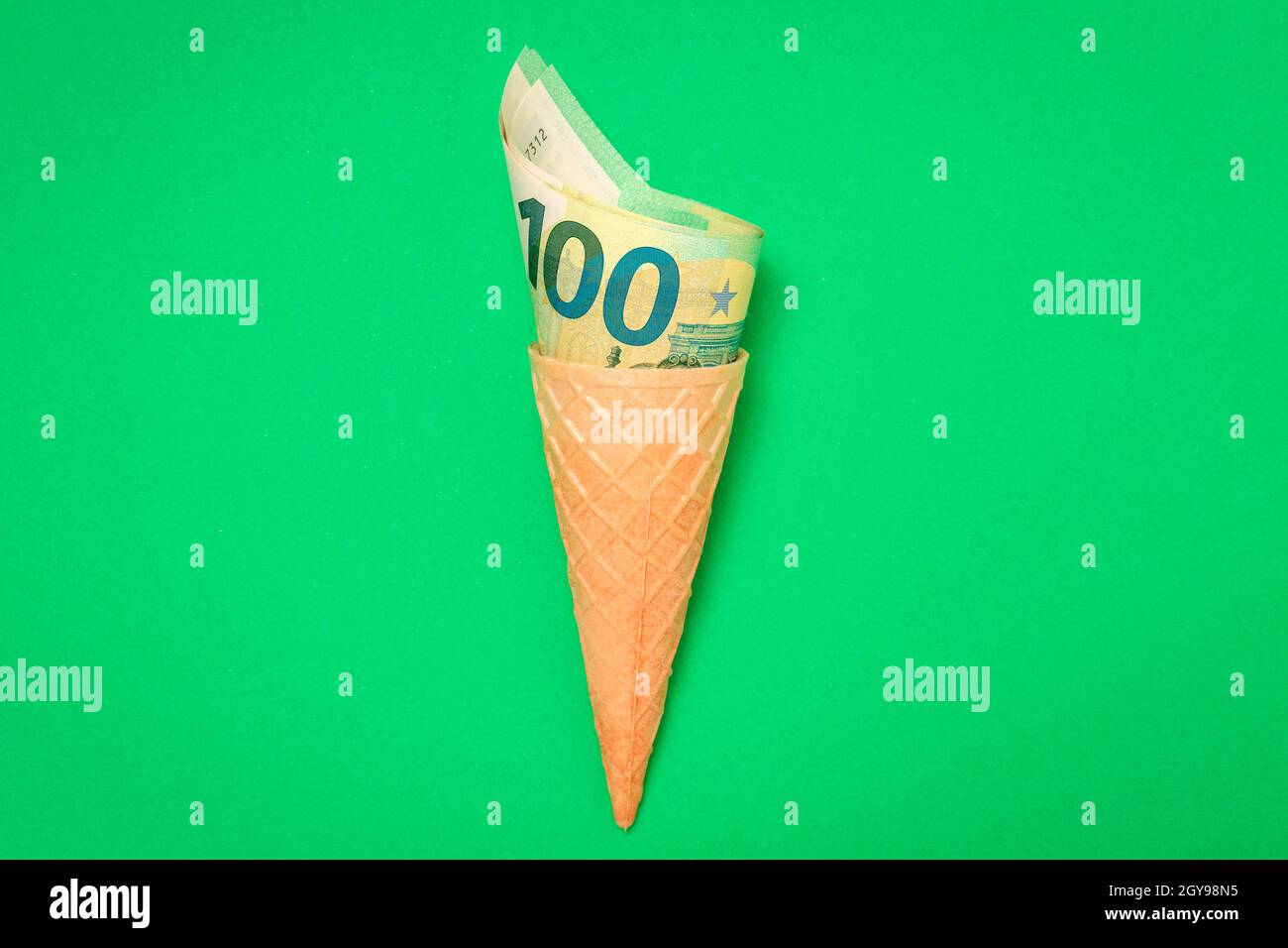 Ice cream wafer cone with one hundred euros banknotes Stock Photo - Alamy