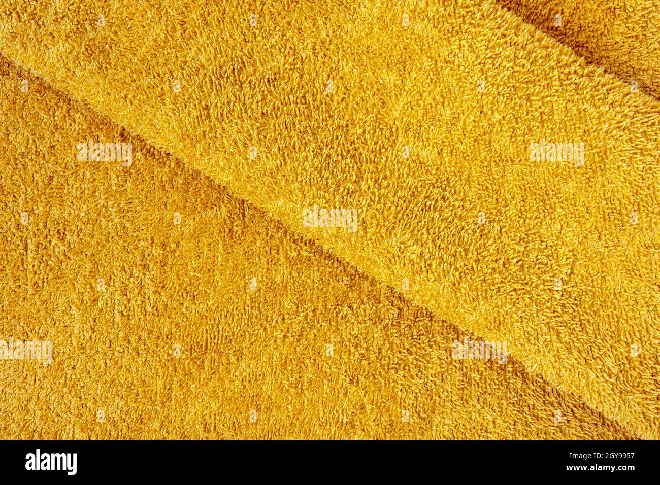 Yellow plush bath towel fabric. Yellow fabric and texture concept ...