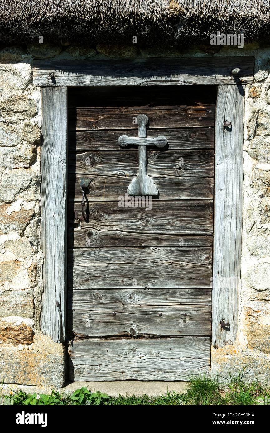 Wooden cross on a door of farm (jasserie), summer pasture specific to ...