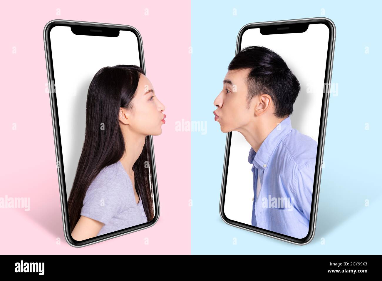 Young couple kissing from the screen of their smartphones Stock Photo ...