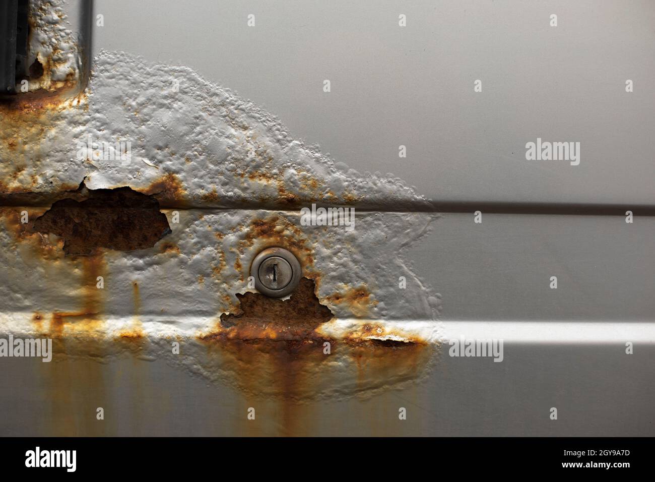 Rust on the car. Surface with damaged paint. Corrosion on metal. A ...