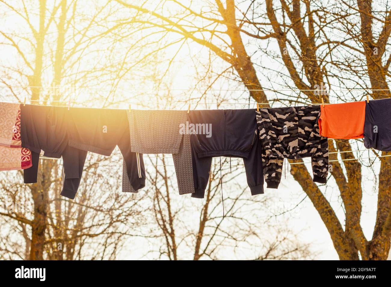 Rope with clean clothes outdoors on laundry day. Colorful clean laundry ...
