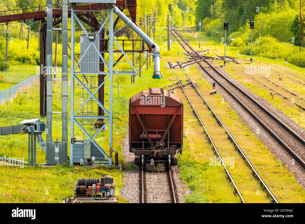 Loading railway wagon standing near the elevator in agriculture zone ...