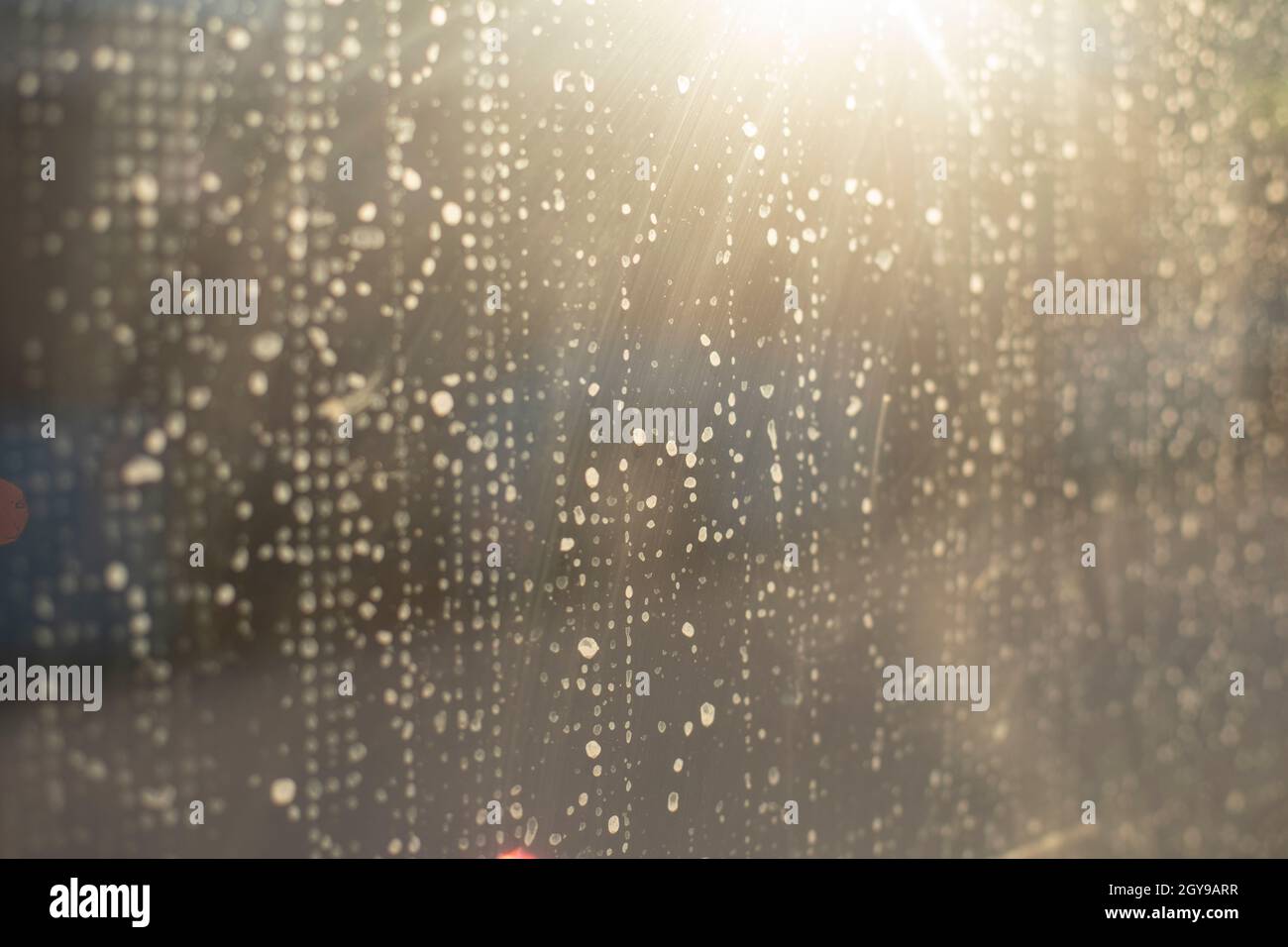 Dirty glass. A lot of dust on the surface of the glass. The sun shines ...