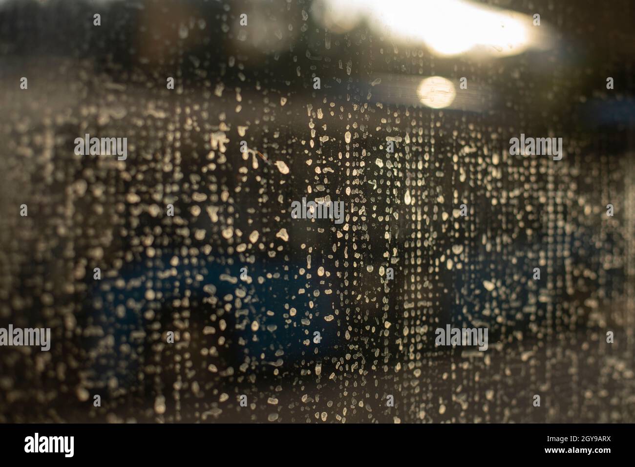 Dirty glass. A lot of dust on the surface of the glass. The sun shines ...