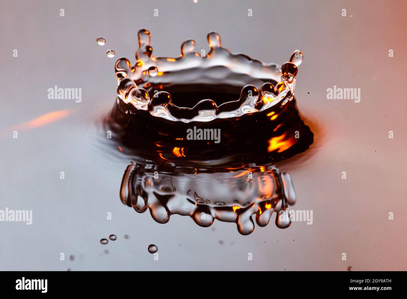 Black and white water drop with a crown shape and a reflection all with ...