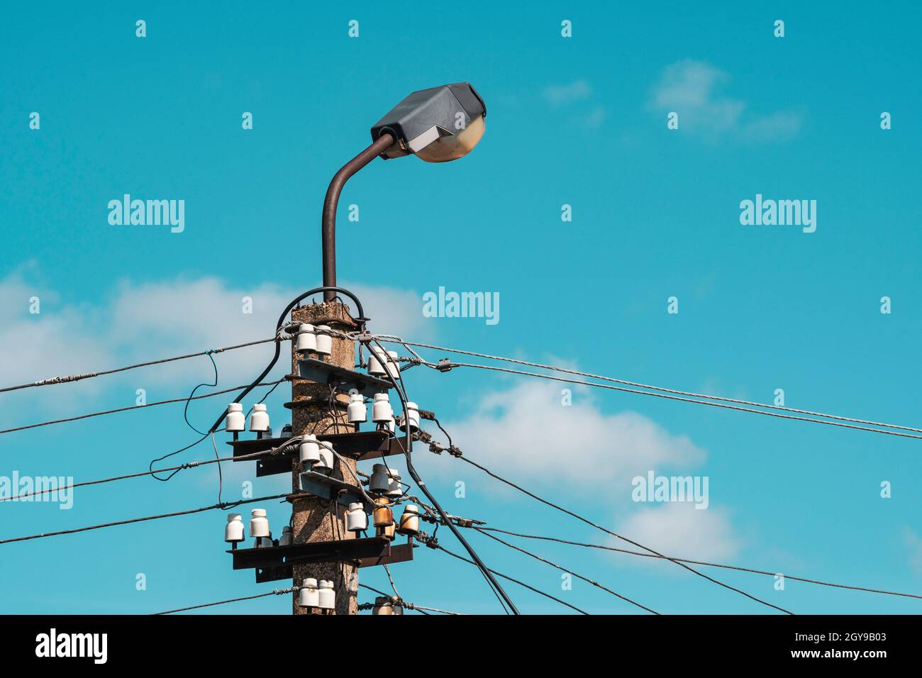 Concrete pylon with wires and street lamp on the sky background Stock ...
