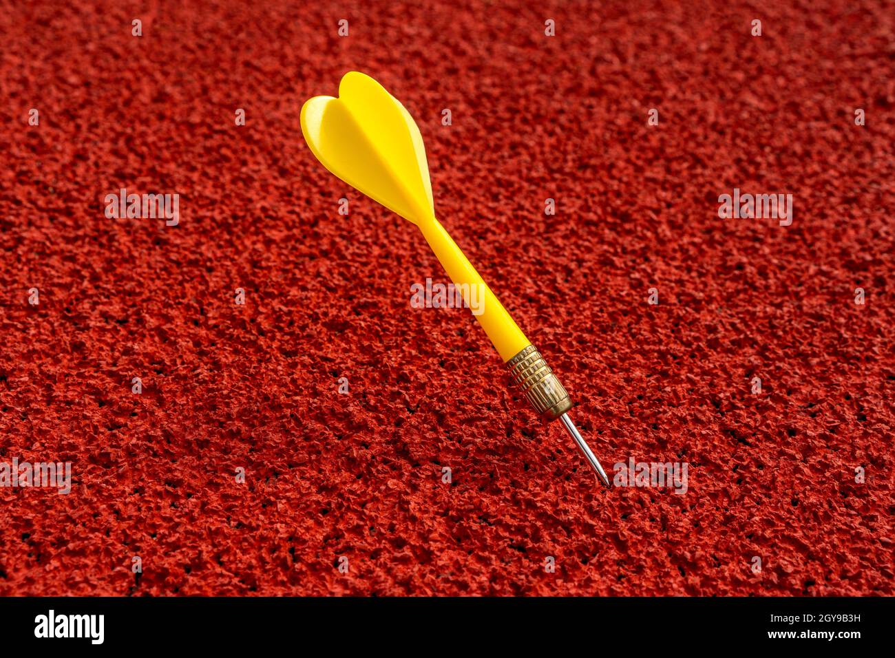 Yellow dart arrow on a running track in a stadium Stock Photo - Alamy