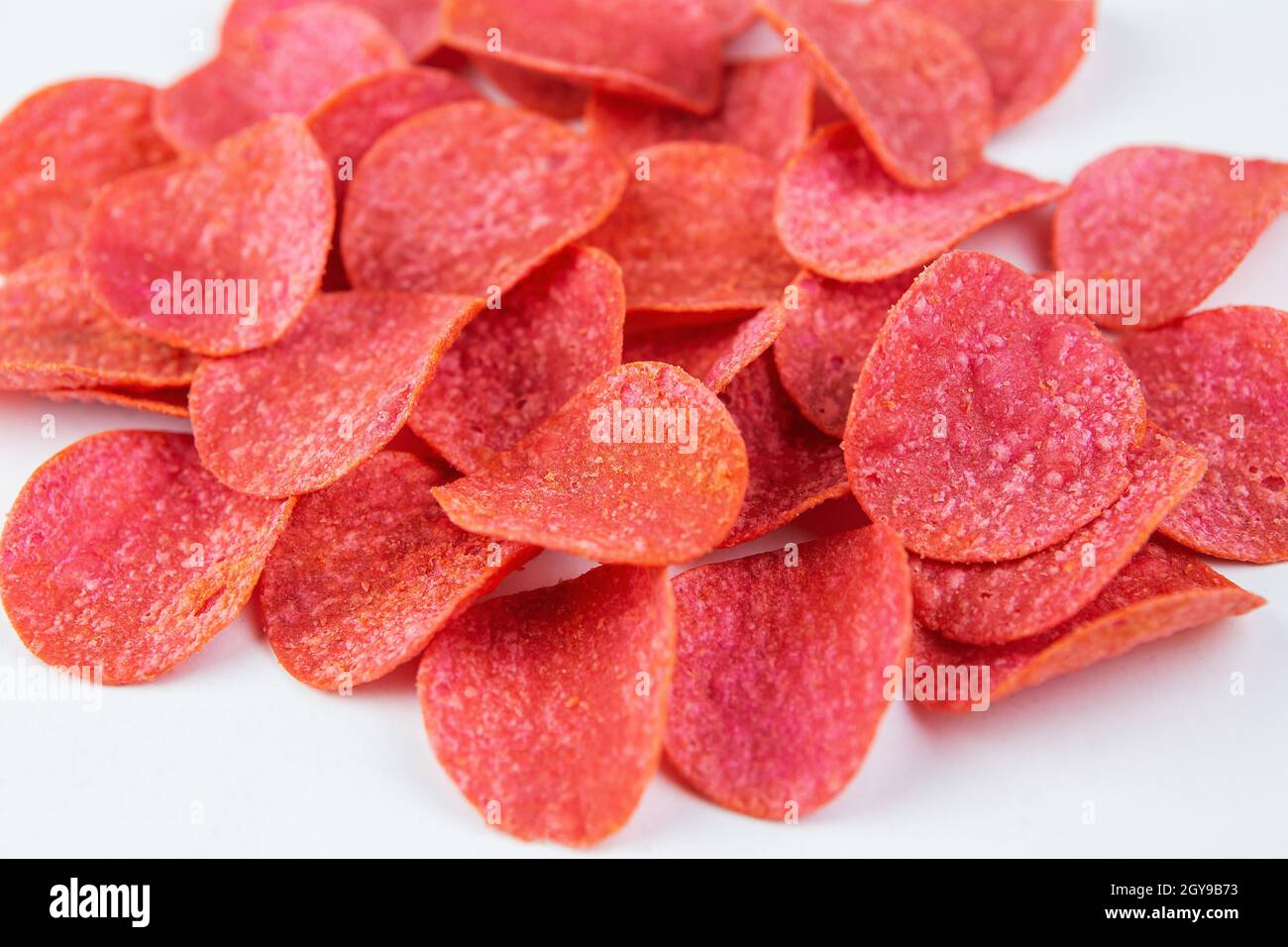 Red chips with hot pepper taste on a white background. Beer snack Stock ...
