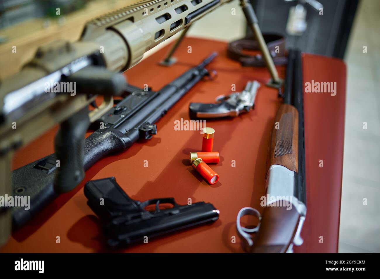 Rifles and pistols on counter in gun store closeup, nobody. Weapon shop ...