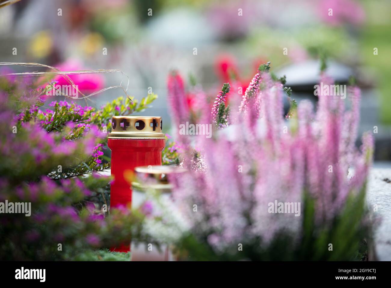 Candle on a grave at a cemetery Stock Photo - Alamy