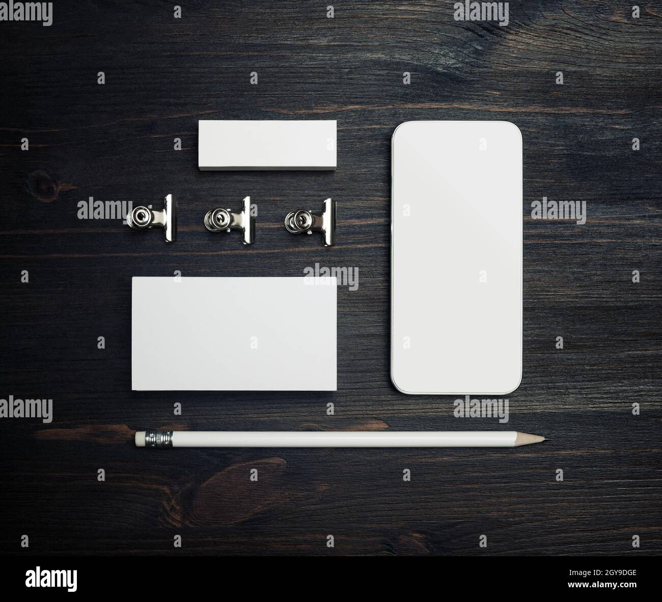 Smartphone and blank stationery: business card, pencil and eraser on ...