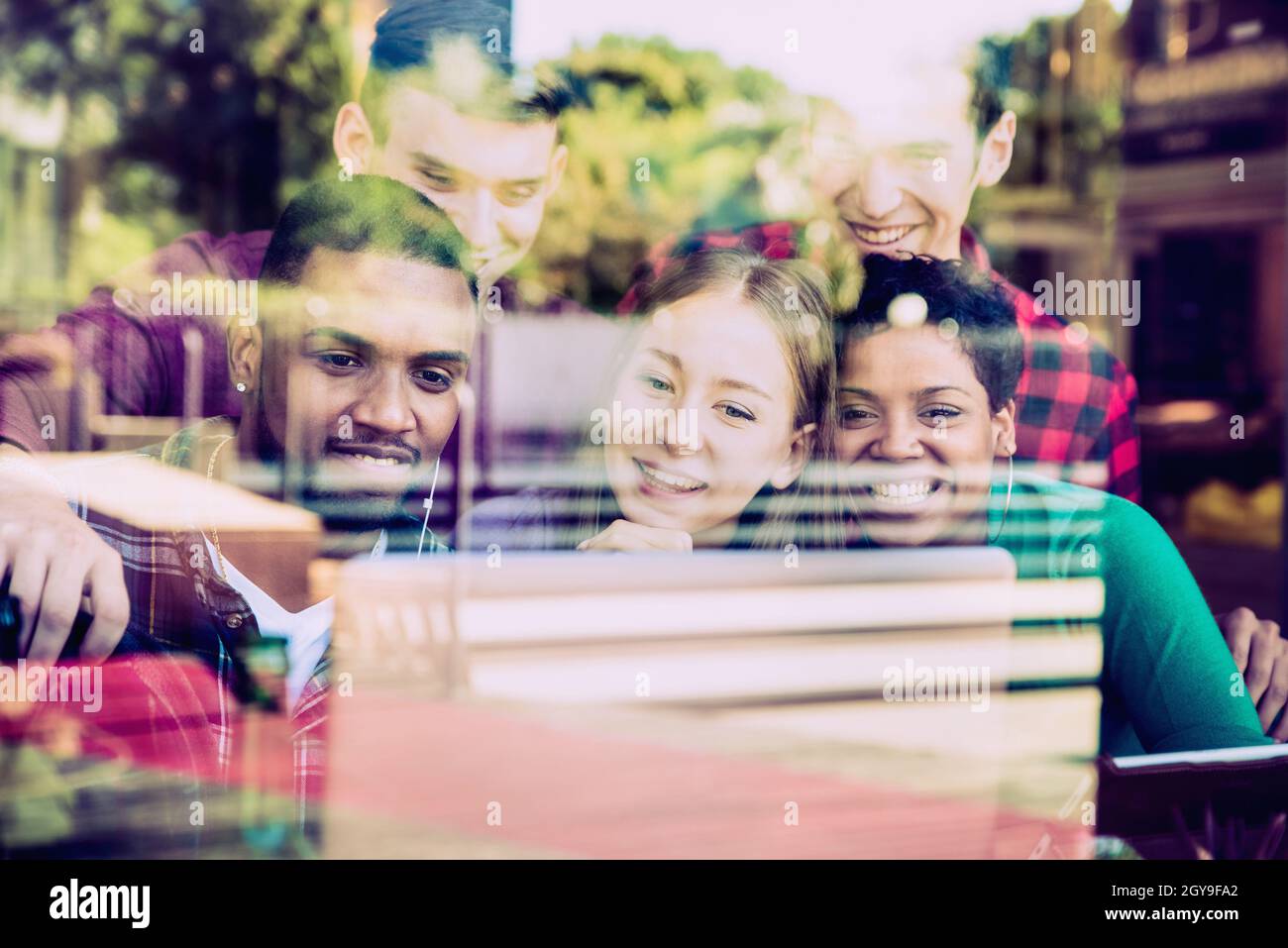 Multiracial best friends group using computer laptop in urban ...