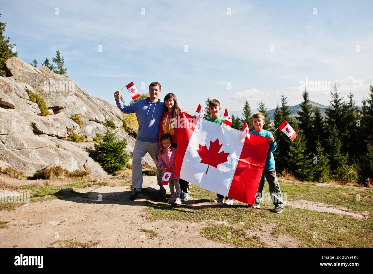 Happy Canada Day. Family with large Canadian flag celebration in ...