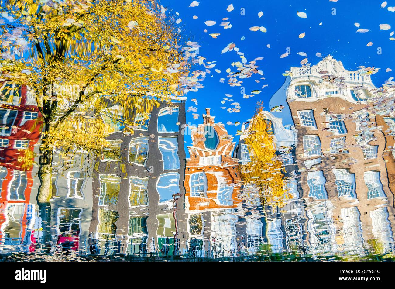 Vibrant reflection of the colorful buildings along the canal in ...
