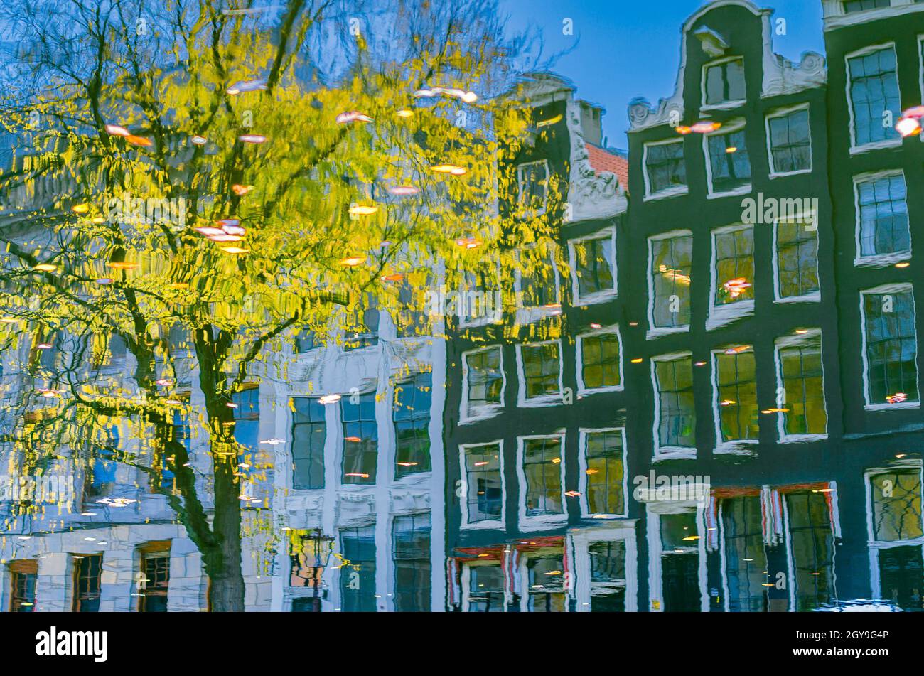 Vibrant reflection of the colorful buildings along the canal in ...