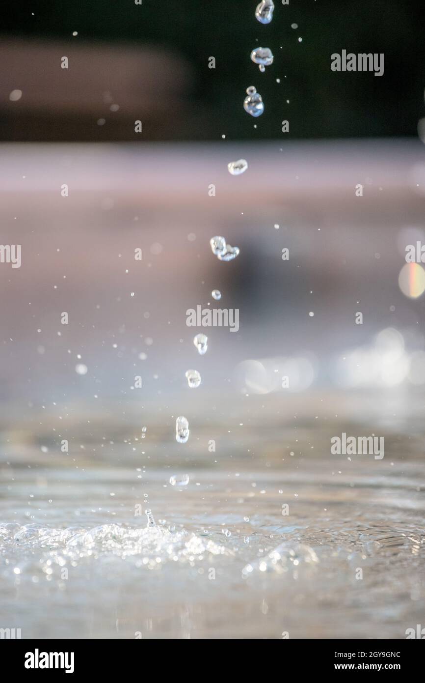 Fresh water drops falling into a well, summer time Stock Photo - Alamy