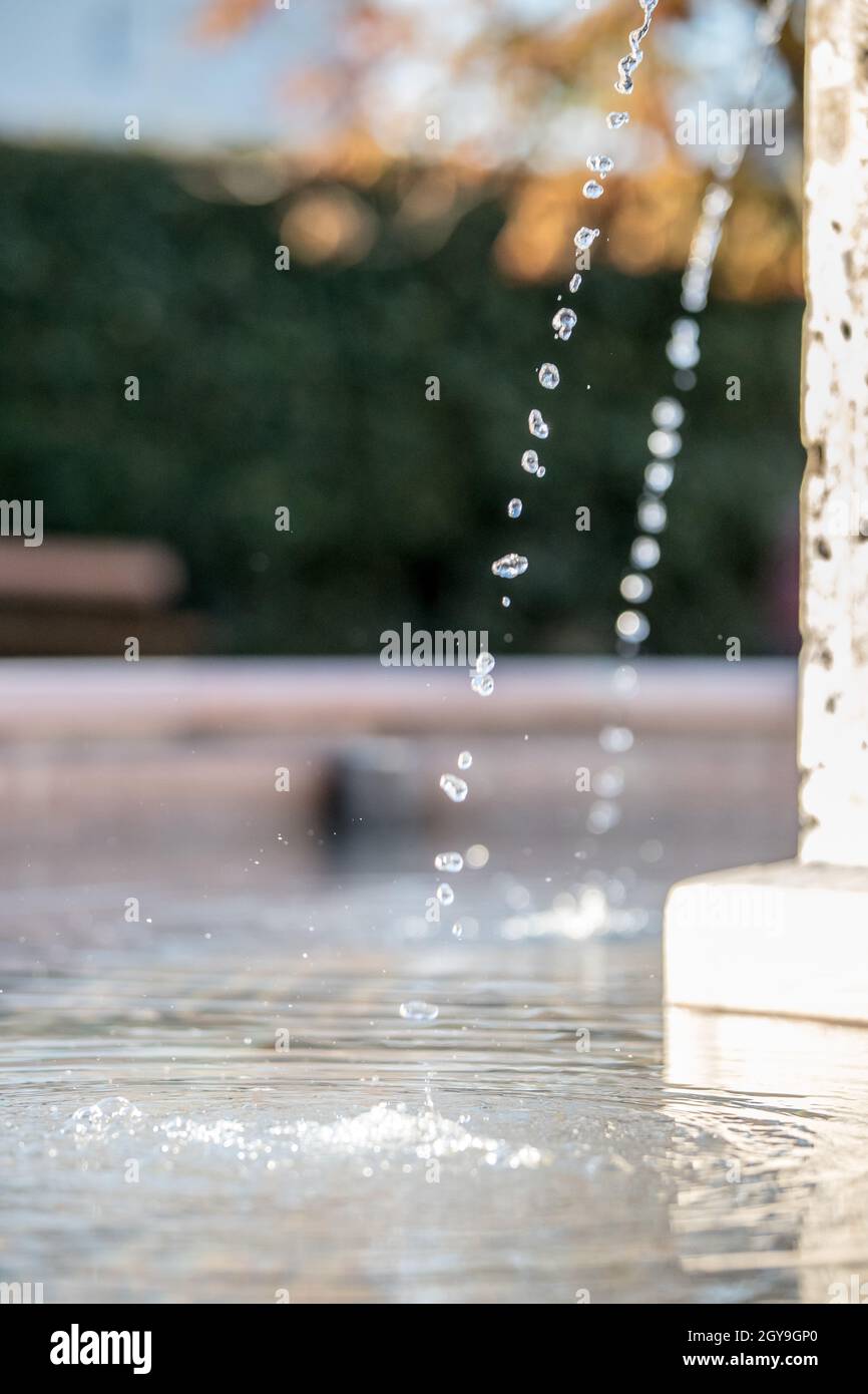 Fresh water drops falling into a well, summer time Stock Photo - Alamy