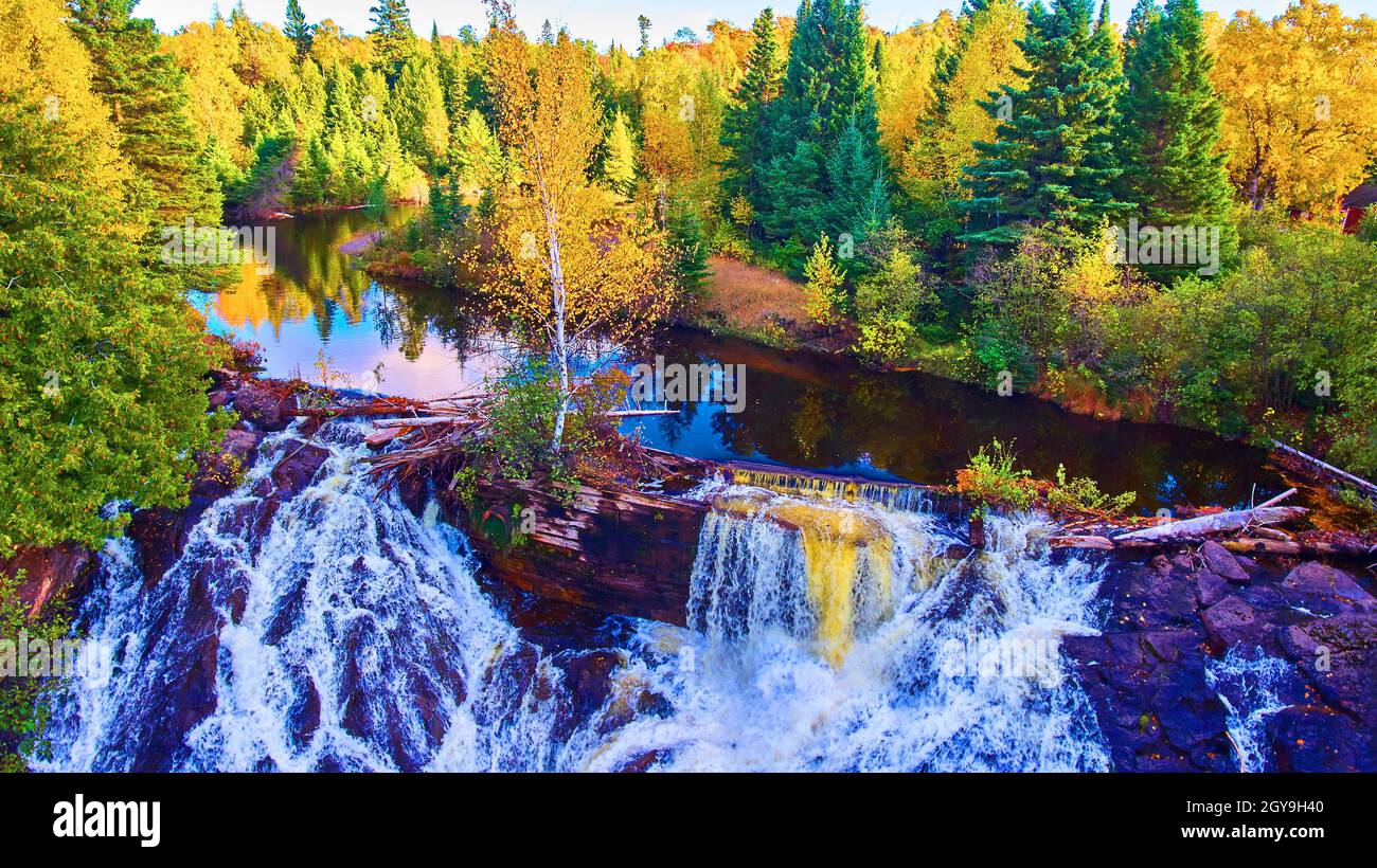 Aerial of Eagle River Falls with natural rock and tree dam and ...