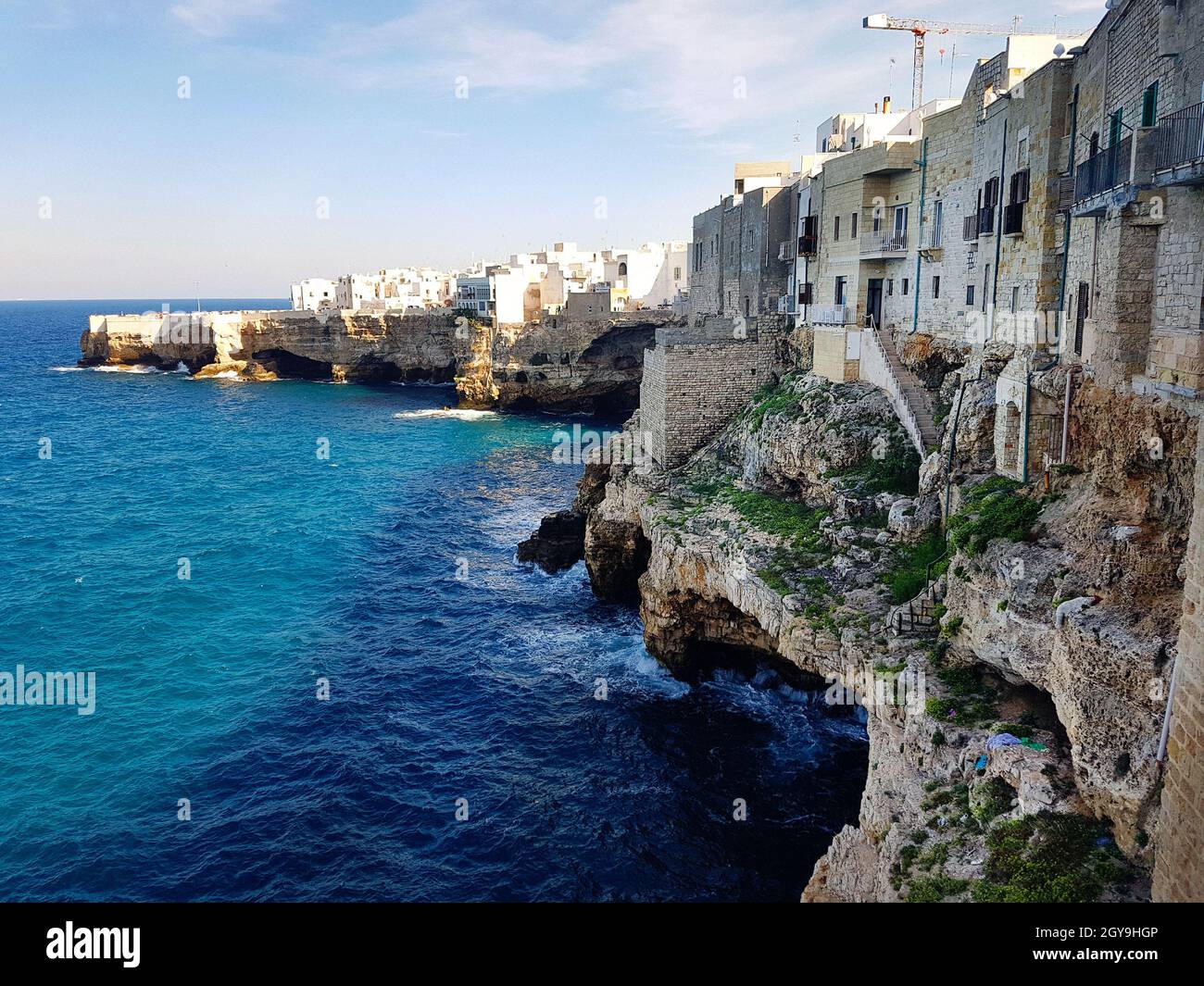 Polignano a Mare view from the seashore with the blue sea. A scenic ...