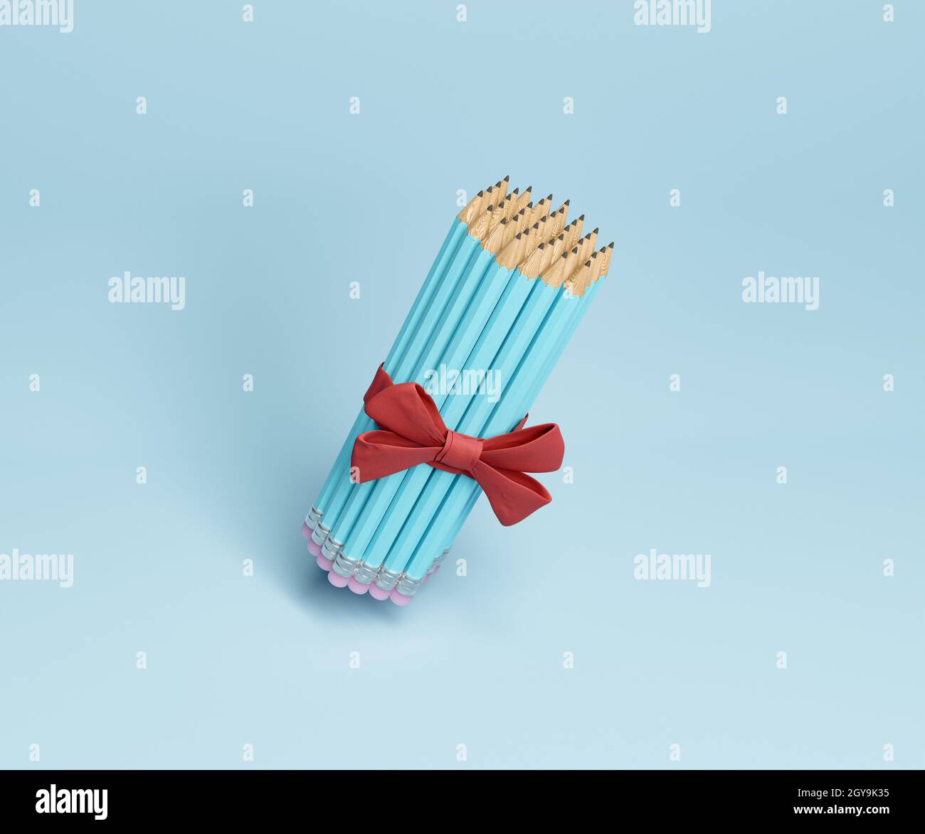 pencils tied with a decorative ribbon and floating on blue background ...