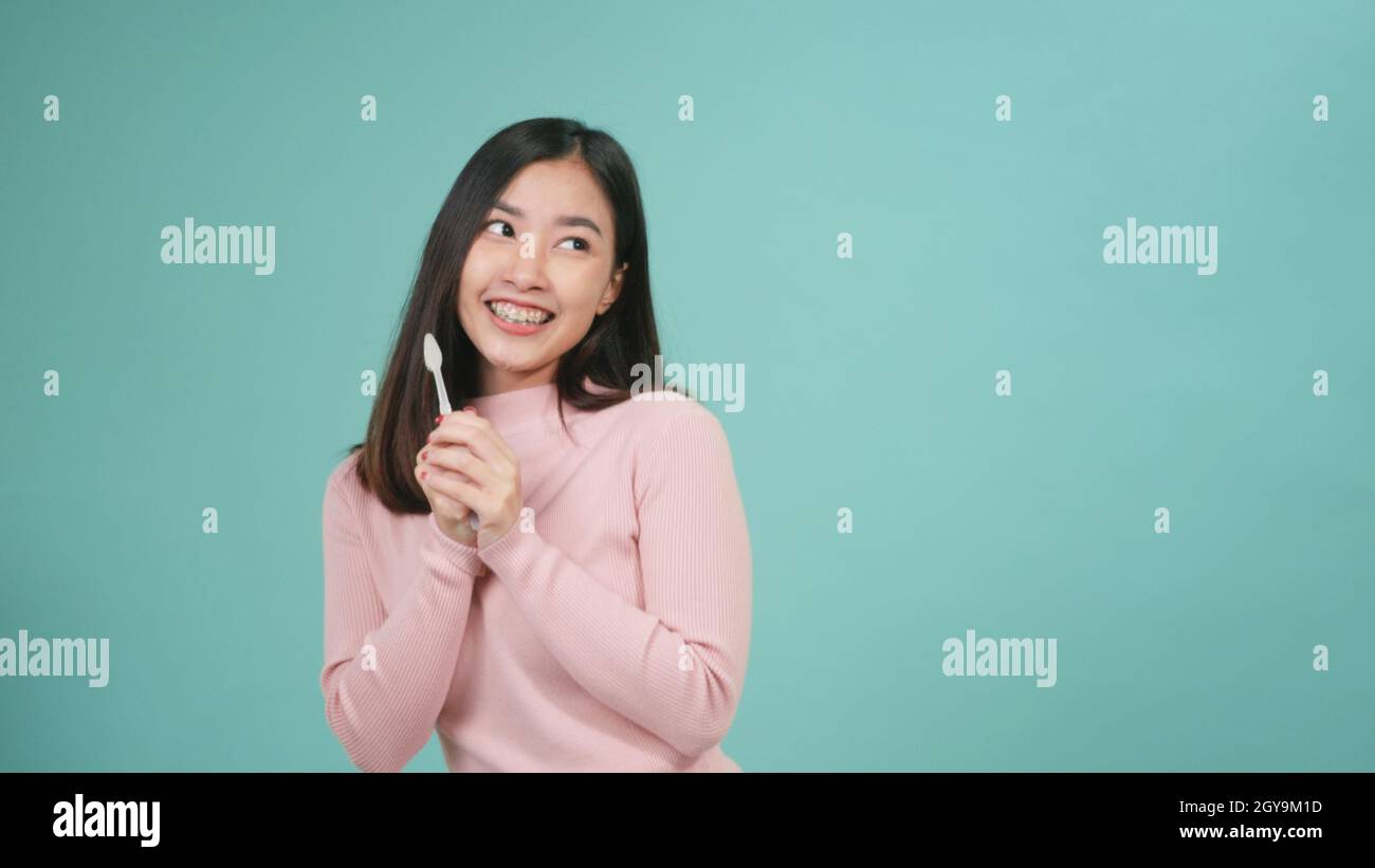 Asian young beautiful woman smile brushing teeth dancing enjoying music ...