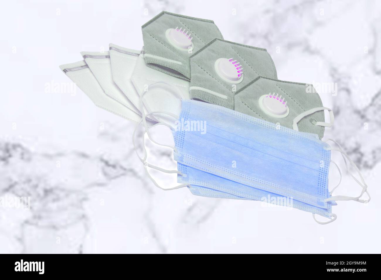 Closeup of grey and white N95 face masks and blue medical face masks ...