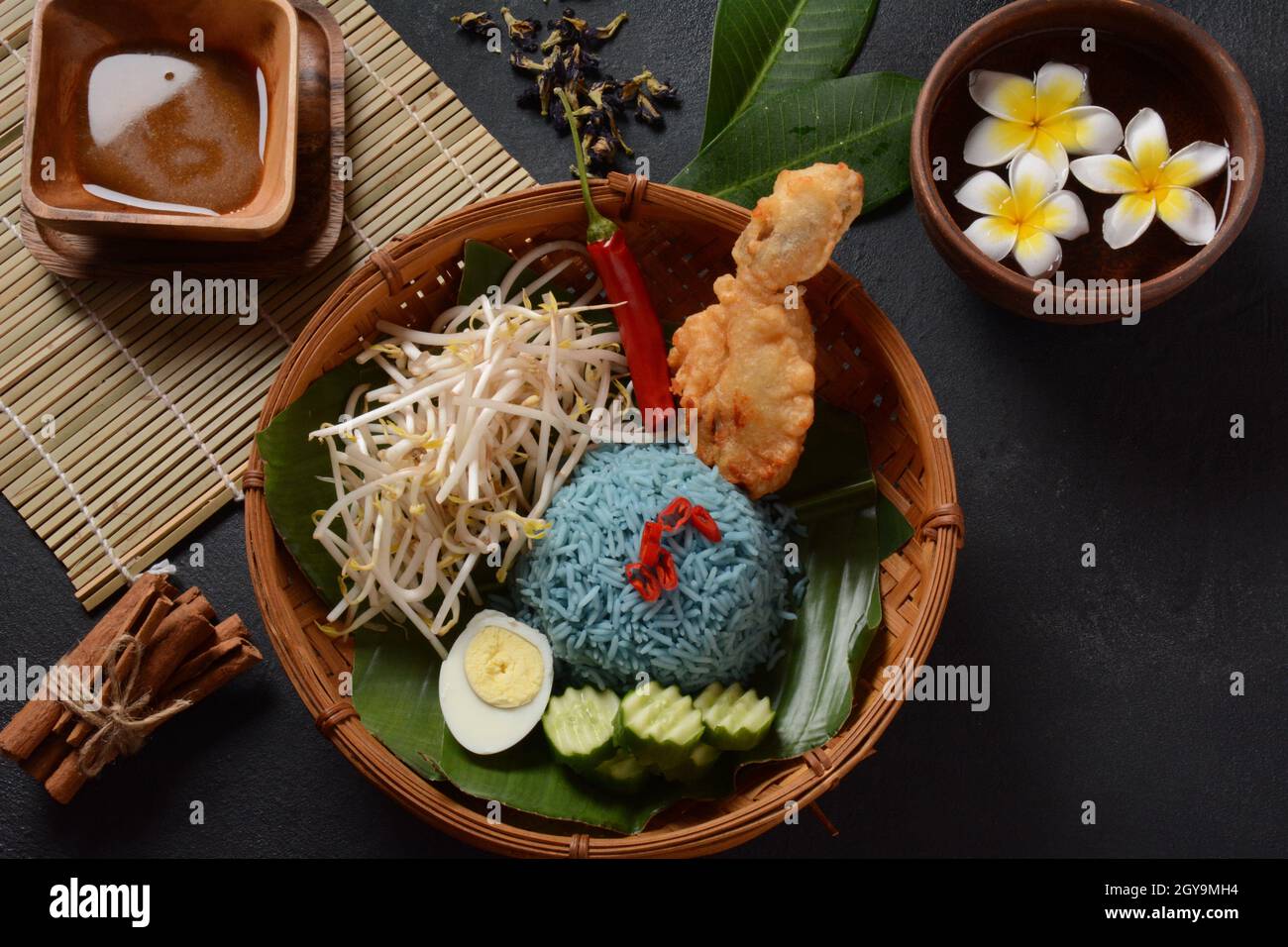 Nasi kerabu or nasi ulam, popular Malay rice dish. Blue color of rice ...