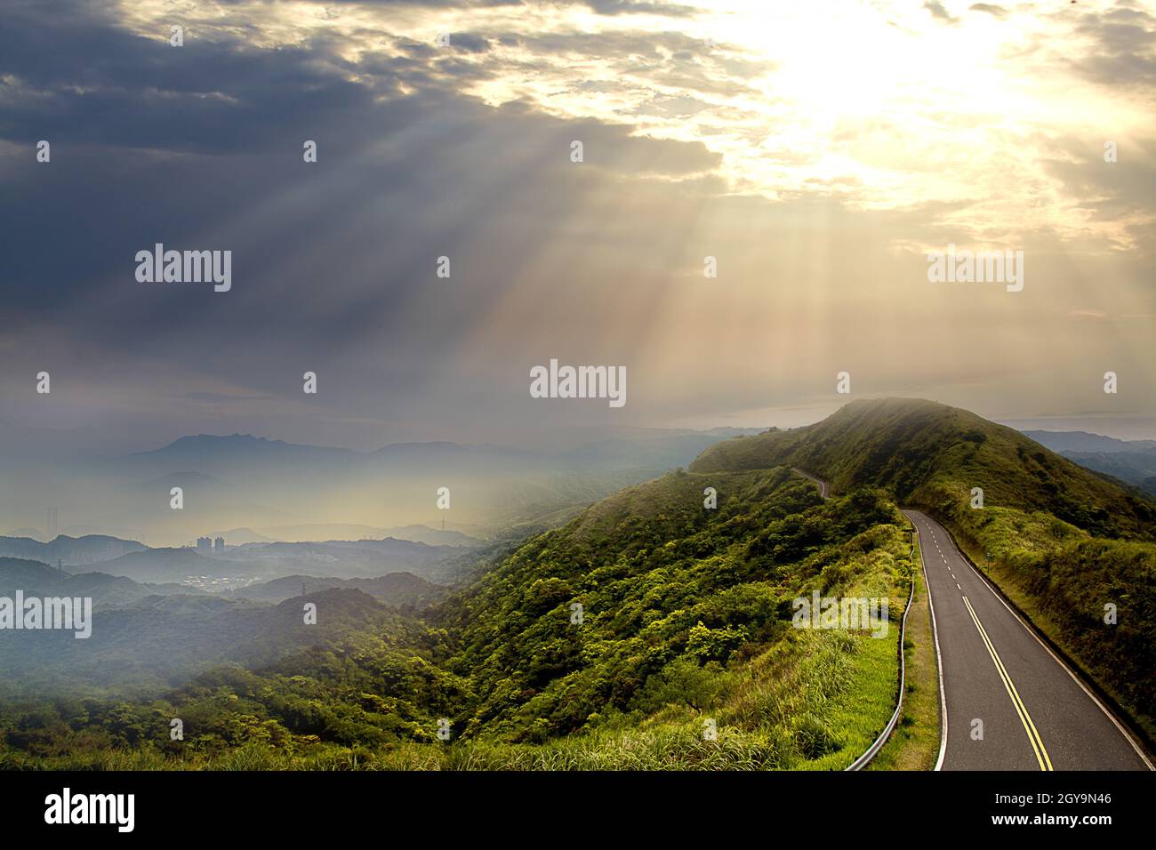 The beautiful road and green mountain with nice lighting at sunset ...
