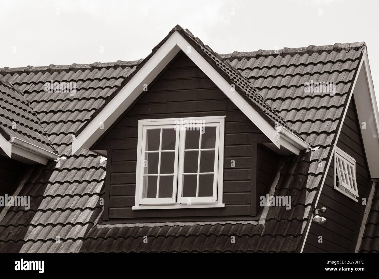 pitched roof dormer loft with white window and concrete tiles Stock ...