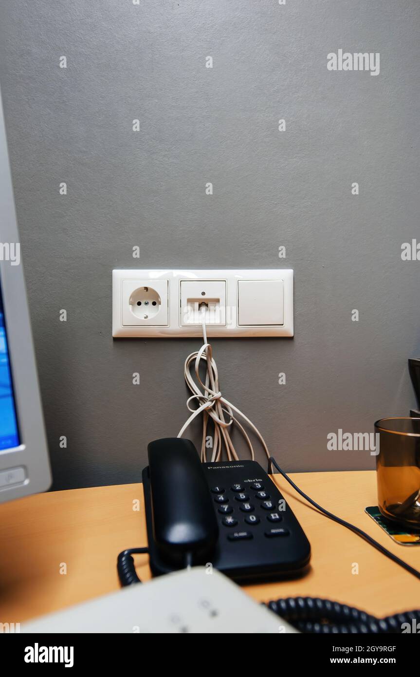 Office table with computer screen, Panasonic corded phone with big ...